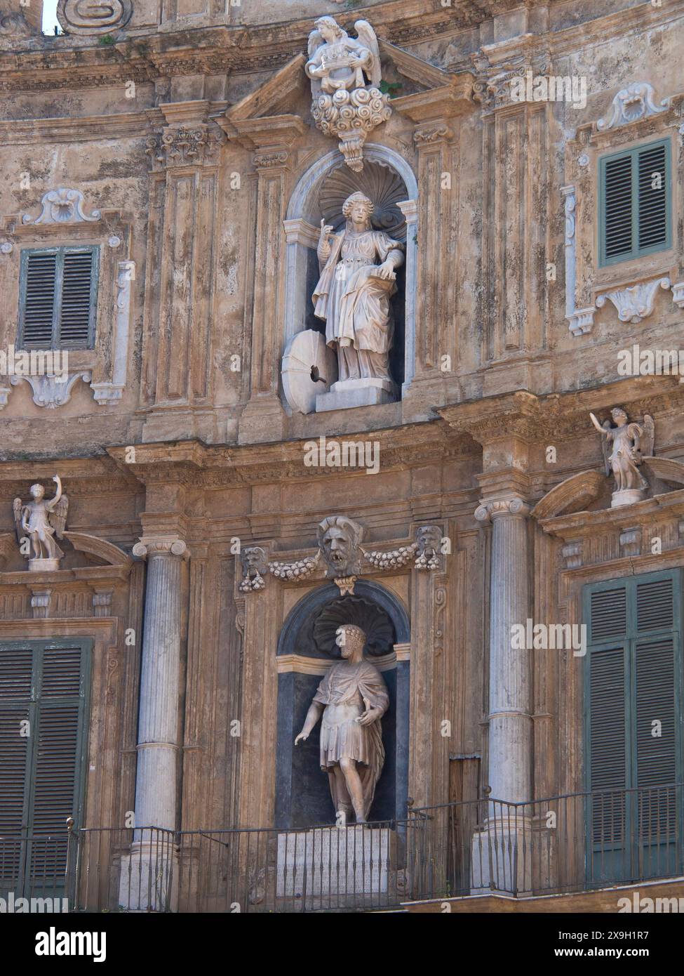 Close-up of an ancient facade with sculptures and reliefs, palermo in ...