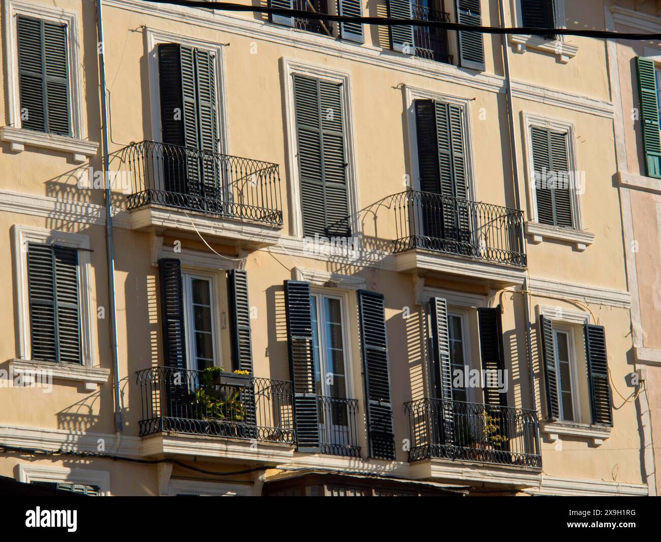 Multi-storey building with many windows, balconies and stucco ...