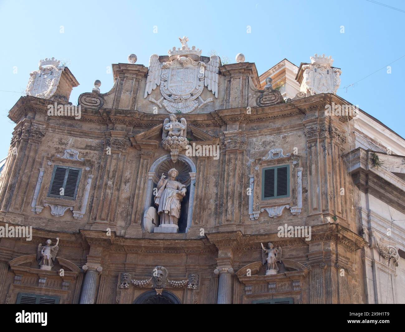 Magnificent baroque building facade with statues and decorations under ...