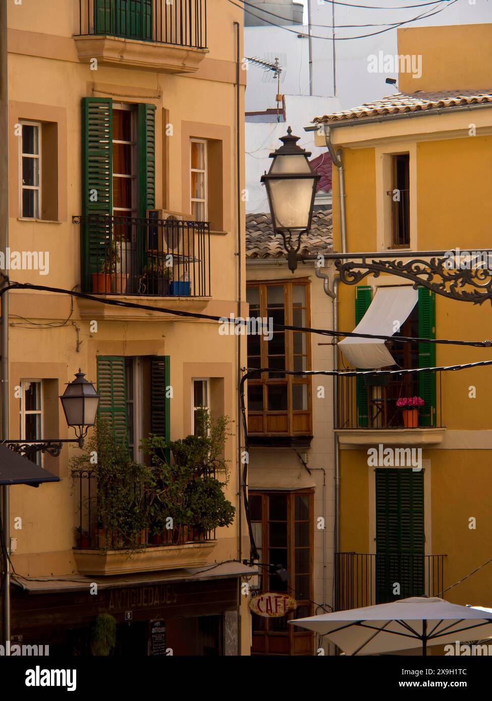 Colourful city facades with windows, balconies and a decorative lantern ...