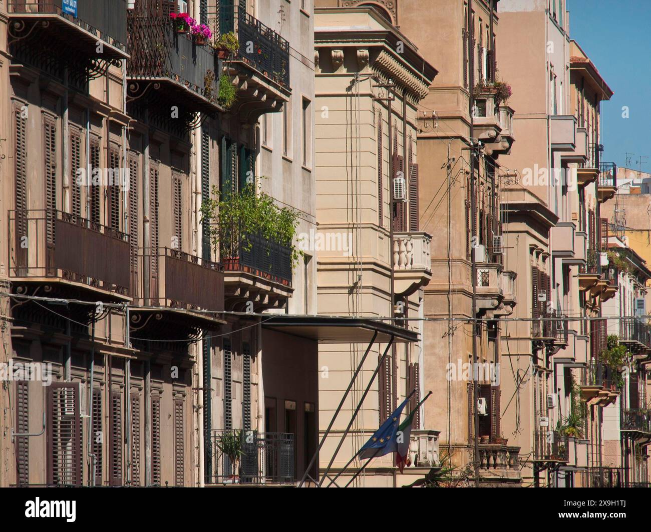 Urban street with elegant facades and balconies under a clear sky ...