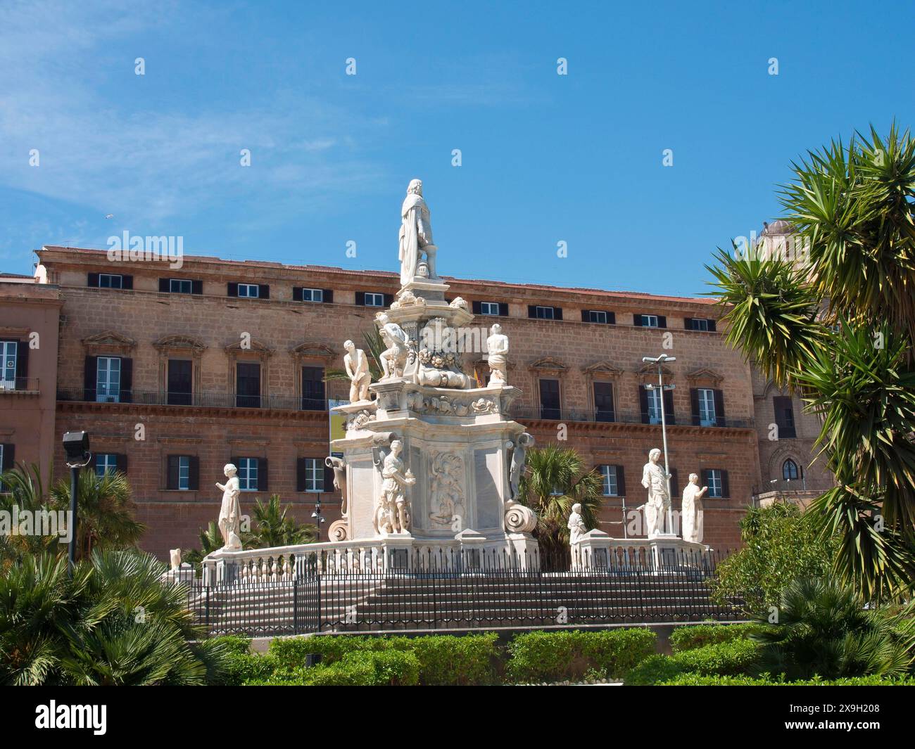 A magnificent fountain with statues in front of a historic building ...