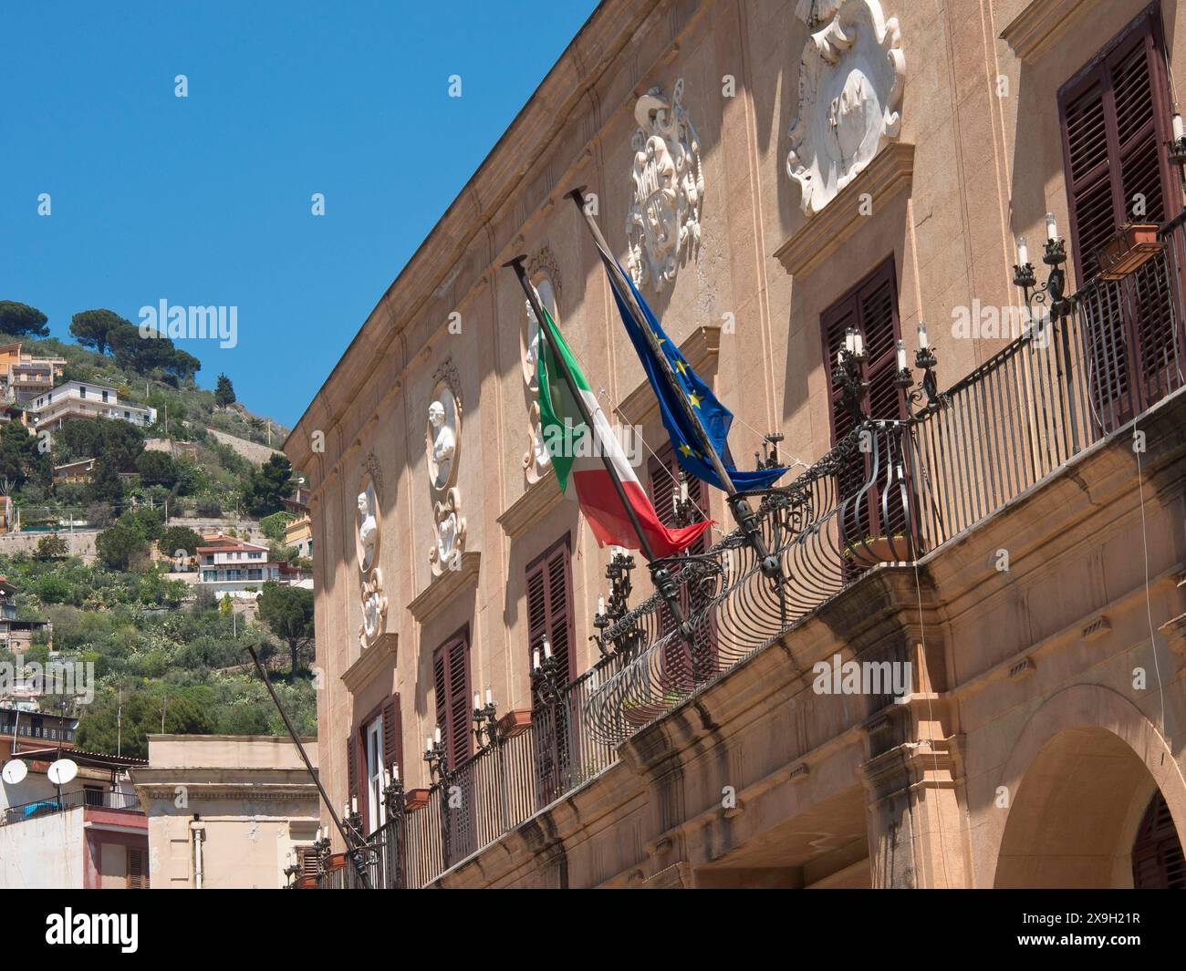 Building with italian and european flag on a balustrade in front of a ...