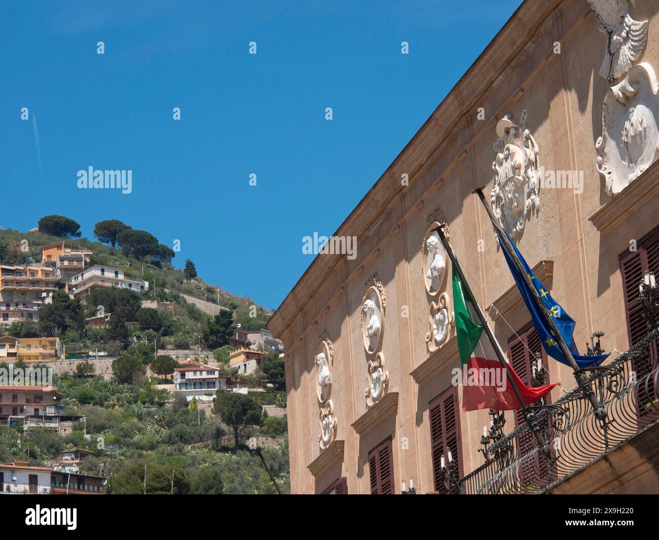 Italian and European flag building decorated and set in a hilly ...