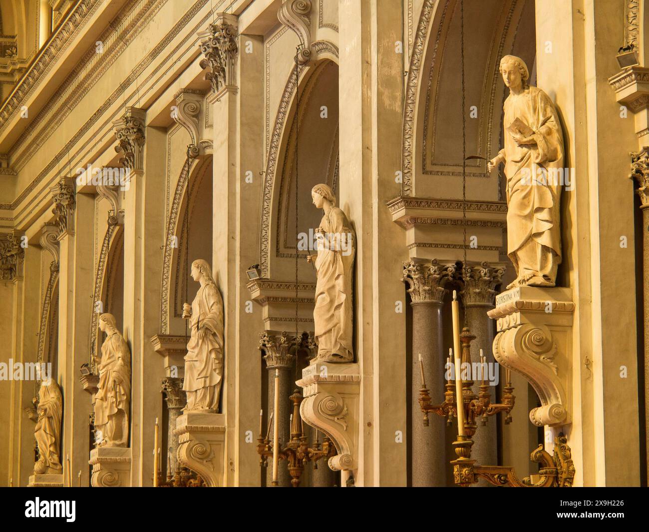 Detailed statues in a baroque church with golden elements and a sacred ...