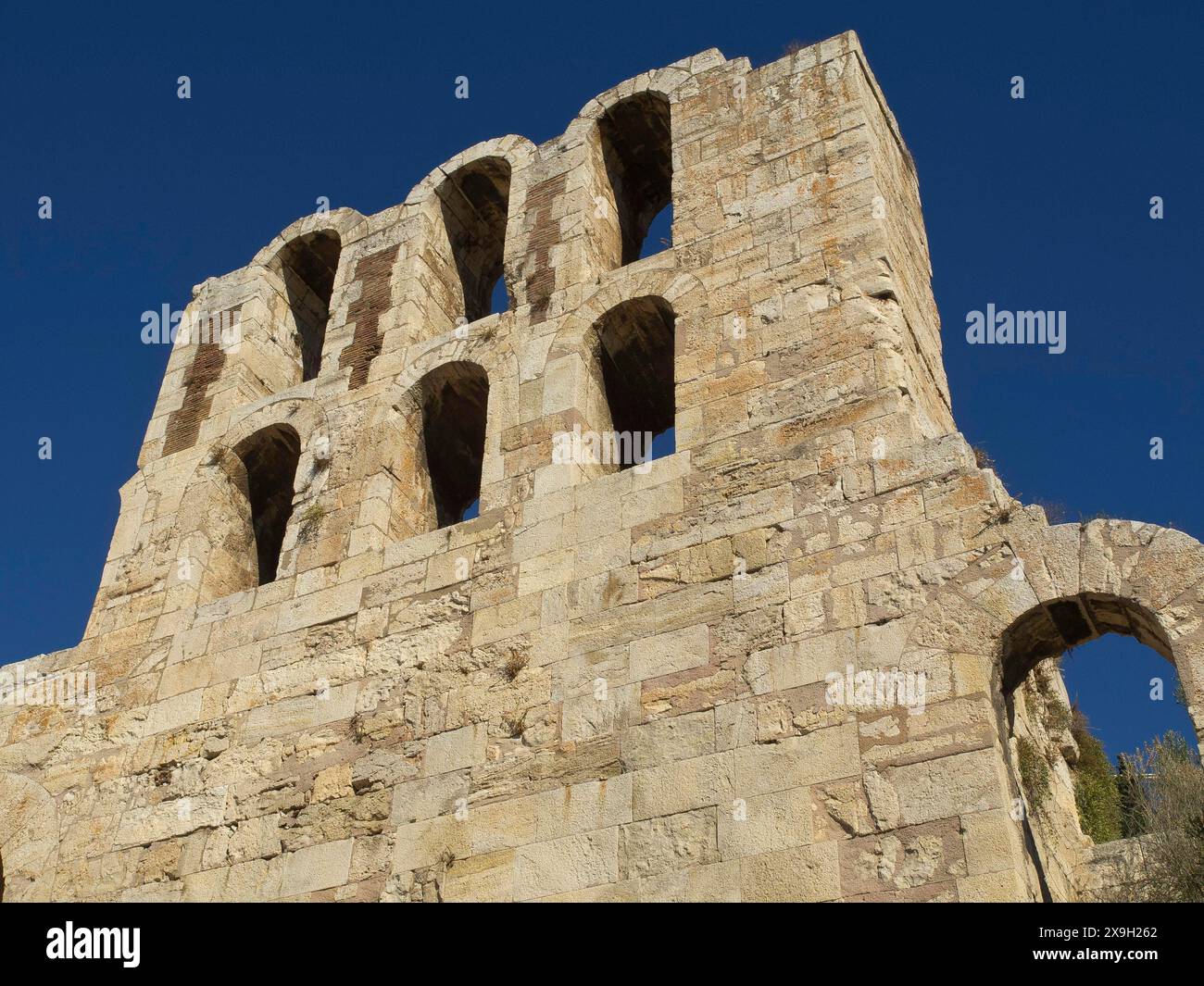 Ancient stone structure with several arches in front of blue sky ...