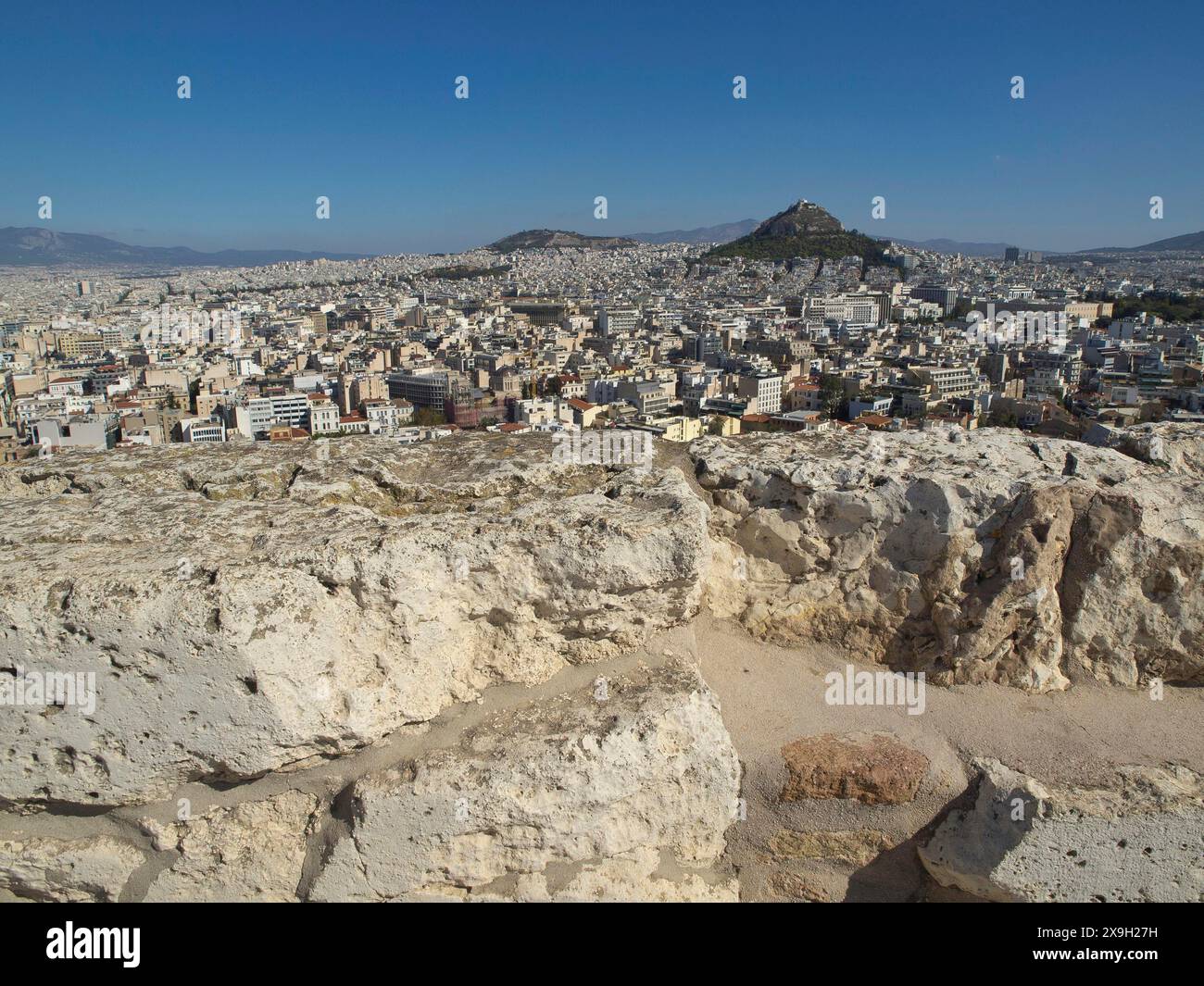 Panoramic view of a city and surrounding mountains from ancient ruins ...