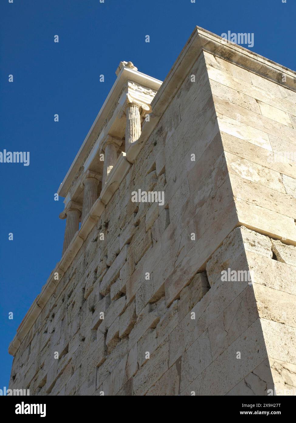 Ancient stone structure in clear blue sky with classical columns ...