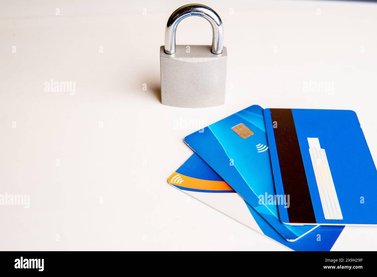 Concept of expense control, a closed padlock and a key next to credit ...