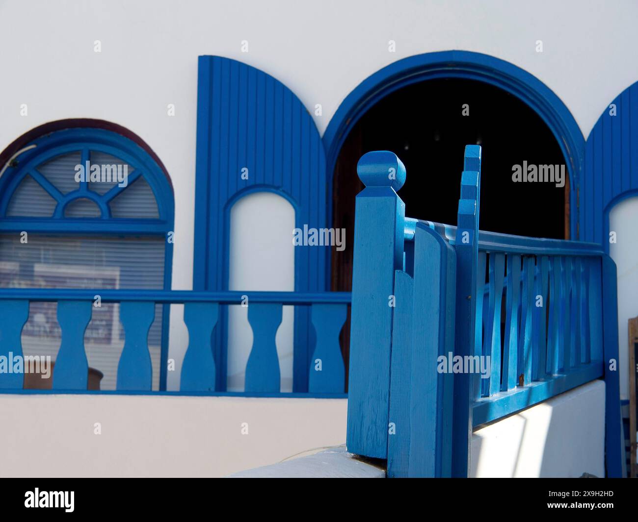 A blue and white building with traditional Greek design elements, The ...