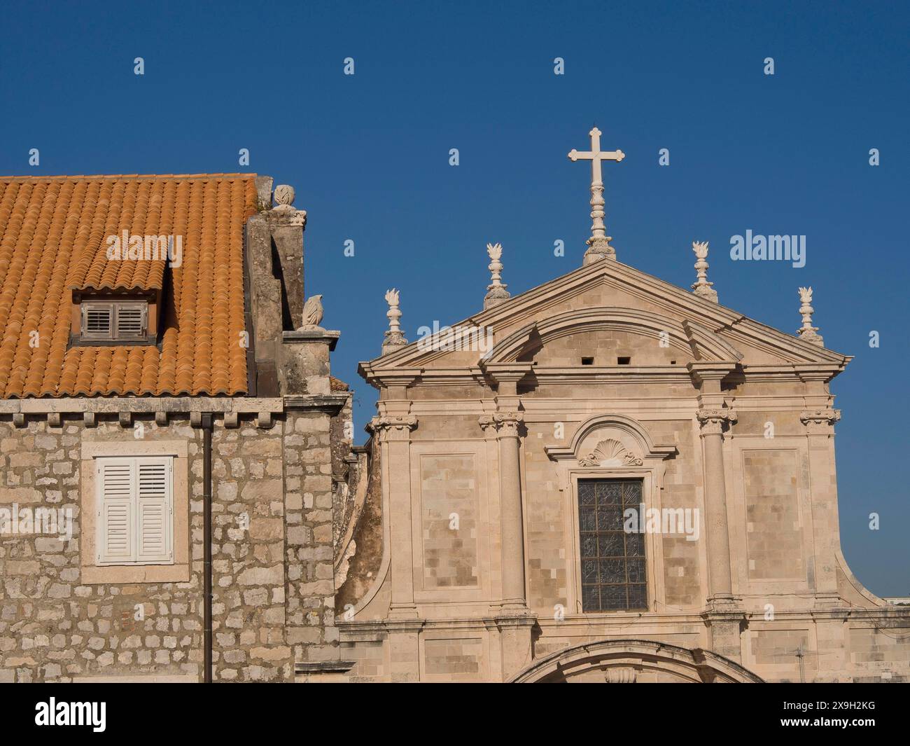 Historic church buildings with crosses and tiled roofs against a blue ...