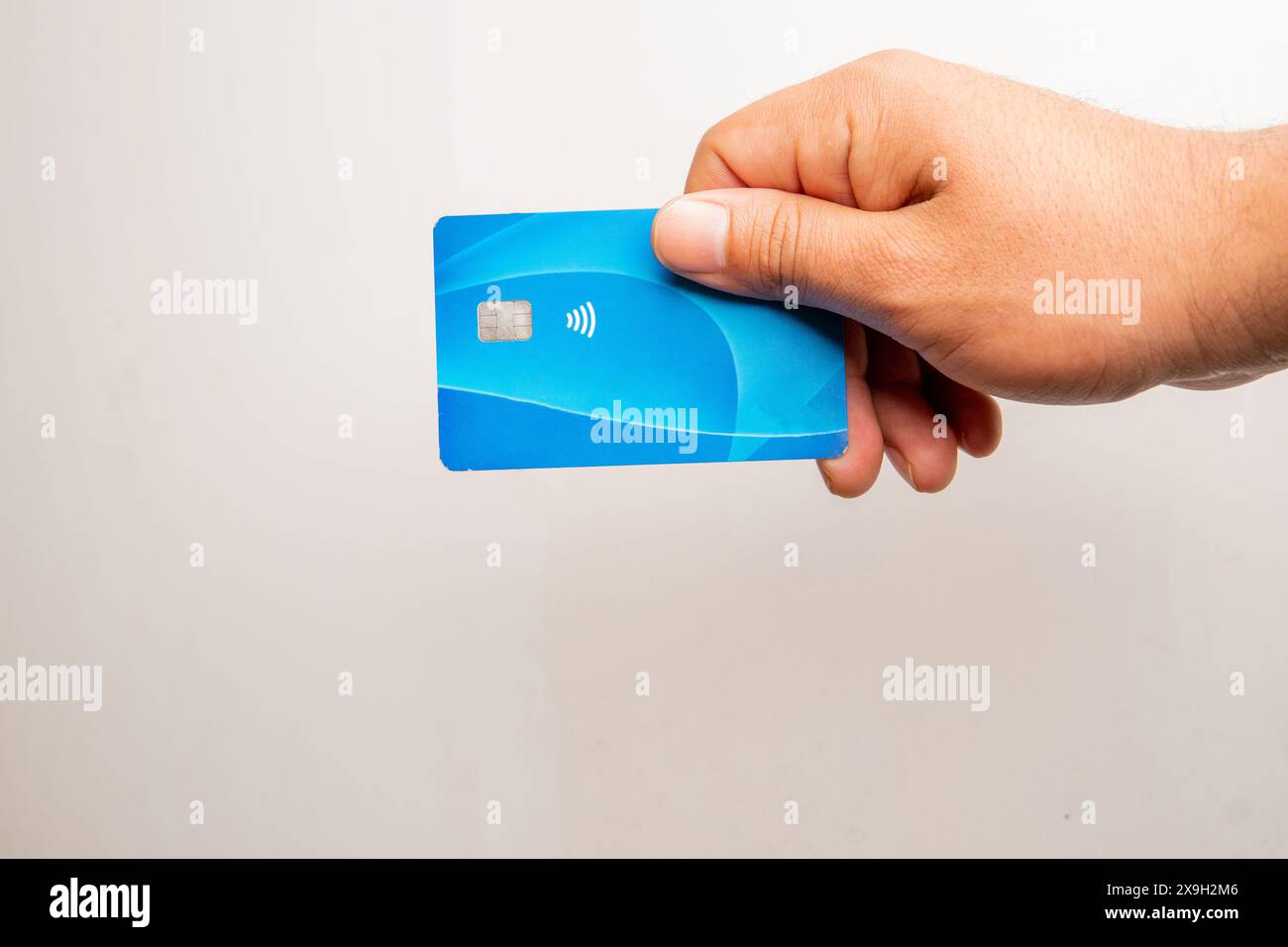 Electronic payments, a hand holding a credit card on a white background ...
