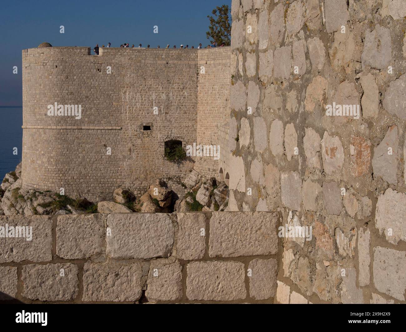 Large old fortress with strong stone walls by the sea under a blue sky ...