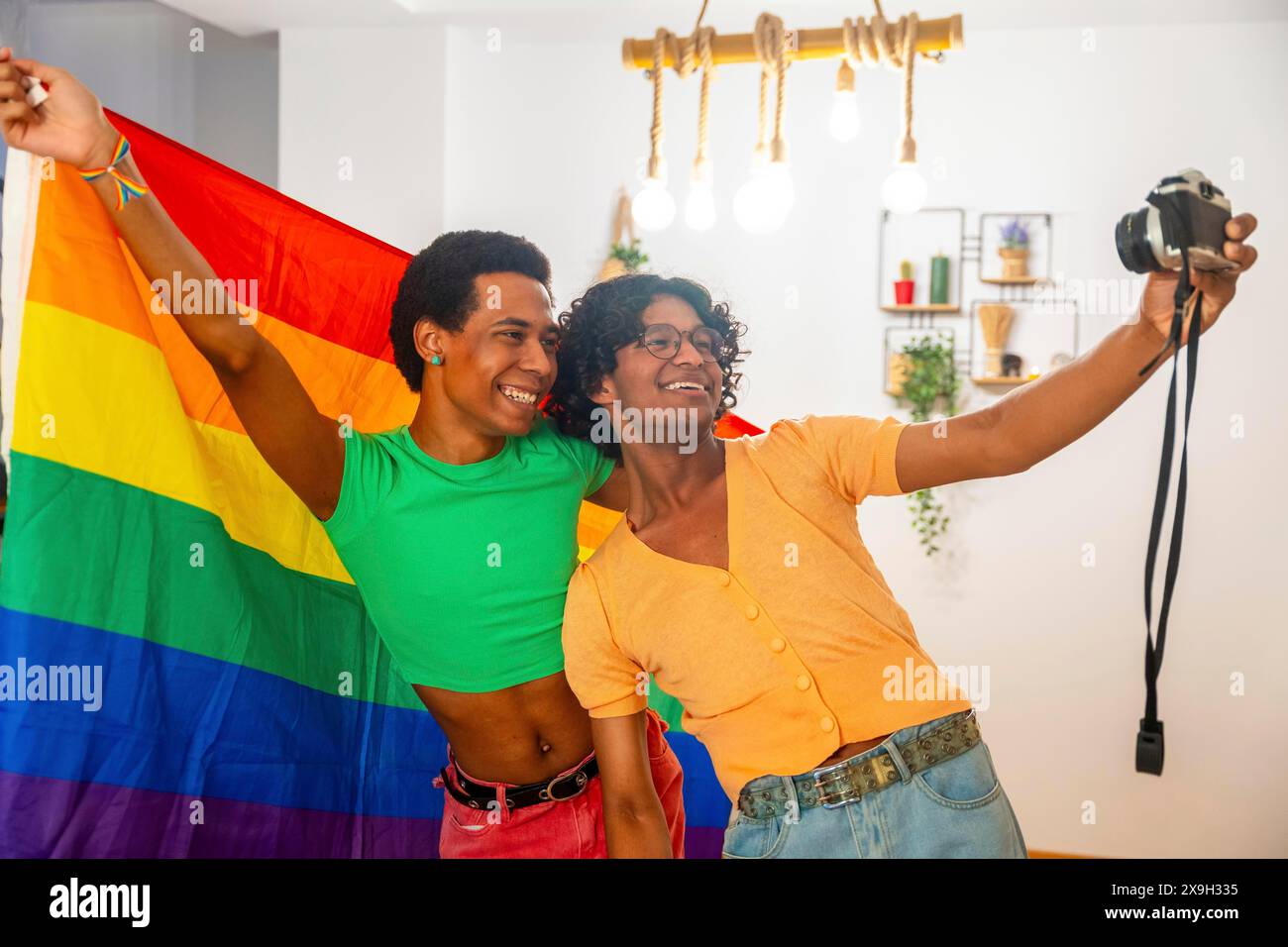Happy gay couple celebrating diversity taking selfie at home raising ...