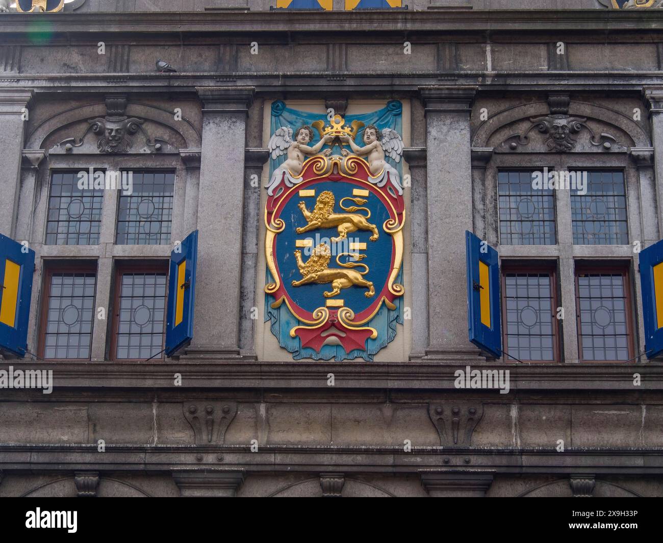 Coat of arms decorated building facade with windows and ornate ...