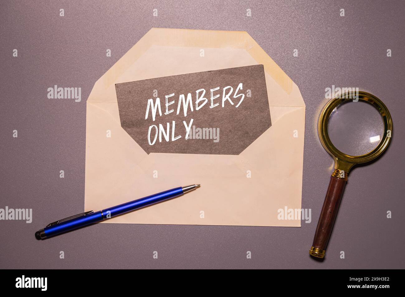 MEMBERS ONLY text on a paper clipboard with chart and notebook on withe ...