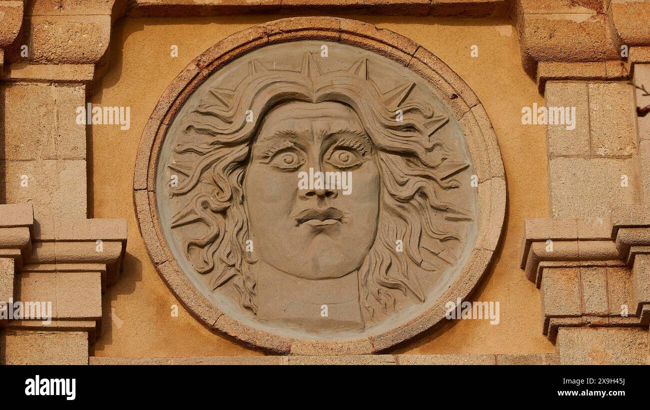 Sun god Helios, close-up of a stone sun face as a relief on an old ...