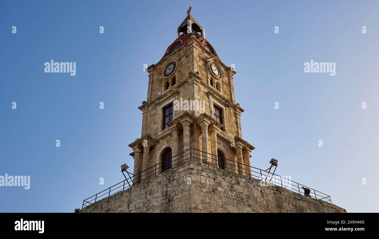 Clock tower, An imposing stone clock tower with battlements under a ...