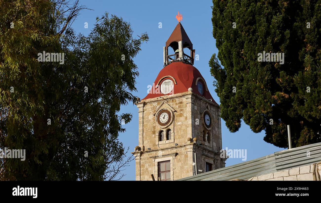 Clock tower, A stone clock tower, nestled between trees, under a blue ...