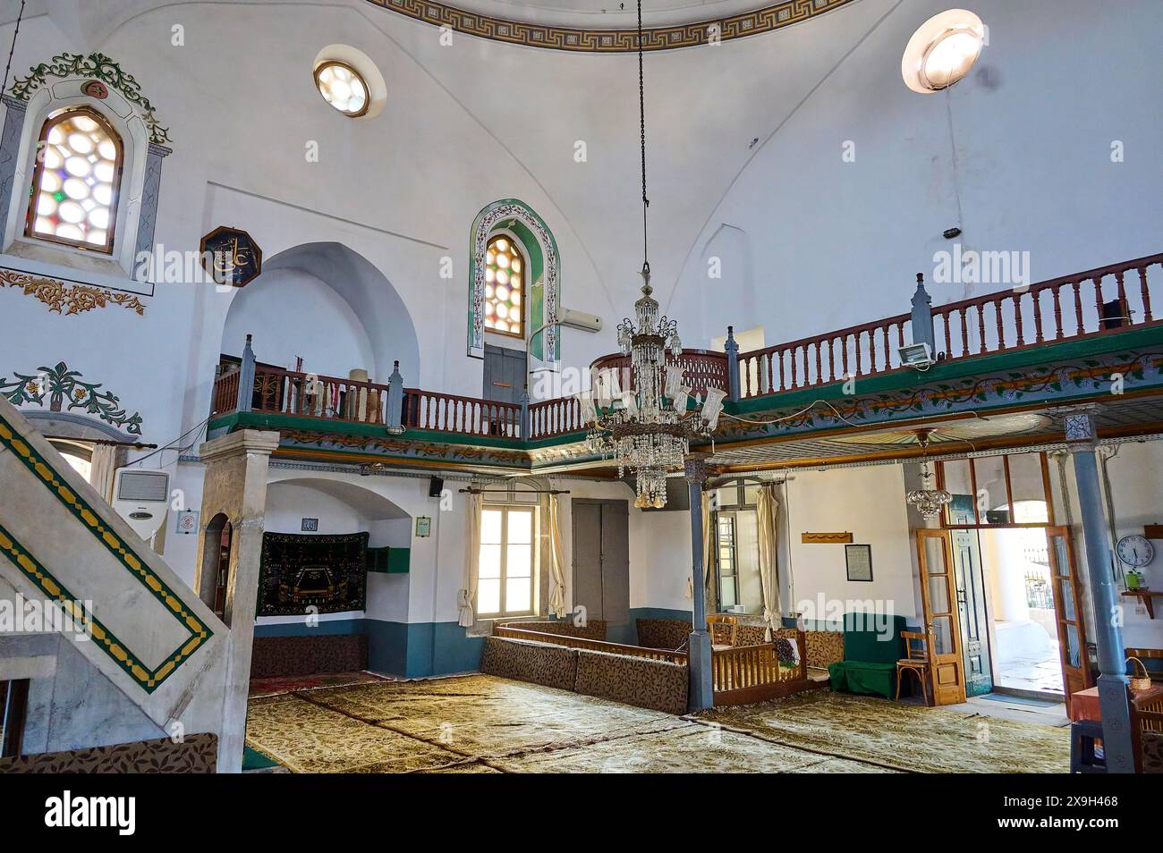 Retzep Pasha Mosque, interior of a mosque with prayer rugs, chandeliers ...
