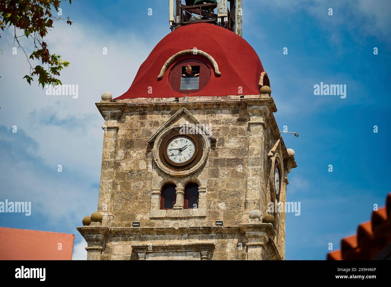 Clock tower, Historic stone tower with a clock and a red roof against a ...