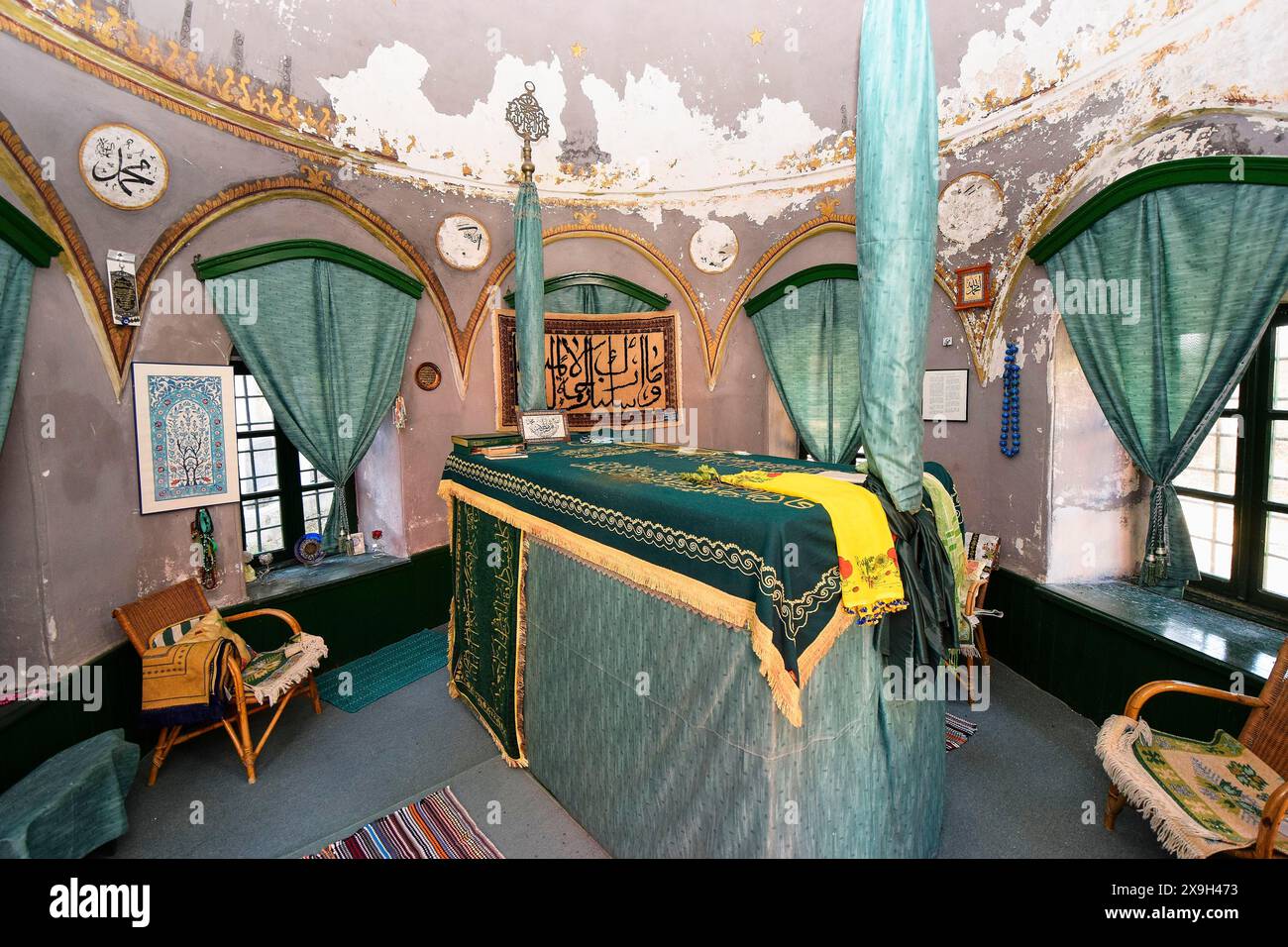 Mausoleum, prayer room with cloth-covered tomb, religious symbols and ...