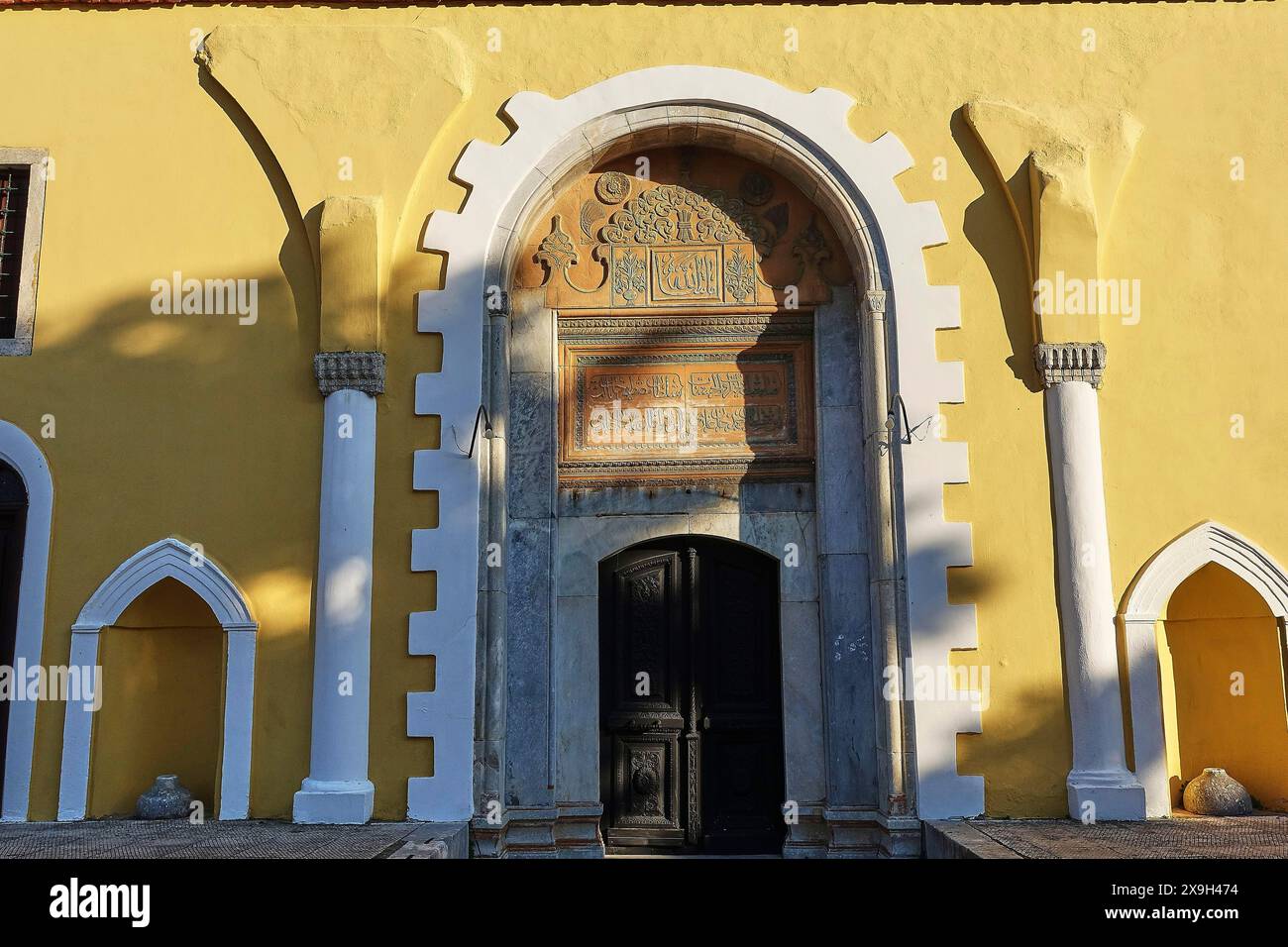 Ottoman Library, Yellow building with a large arch above the entrance ...