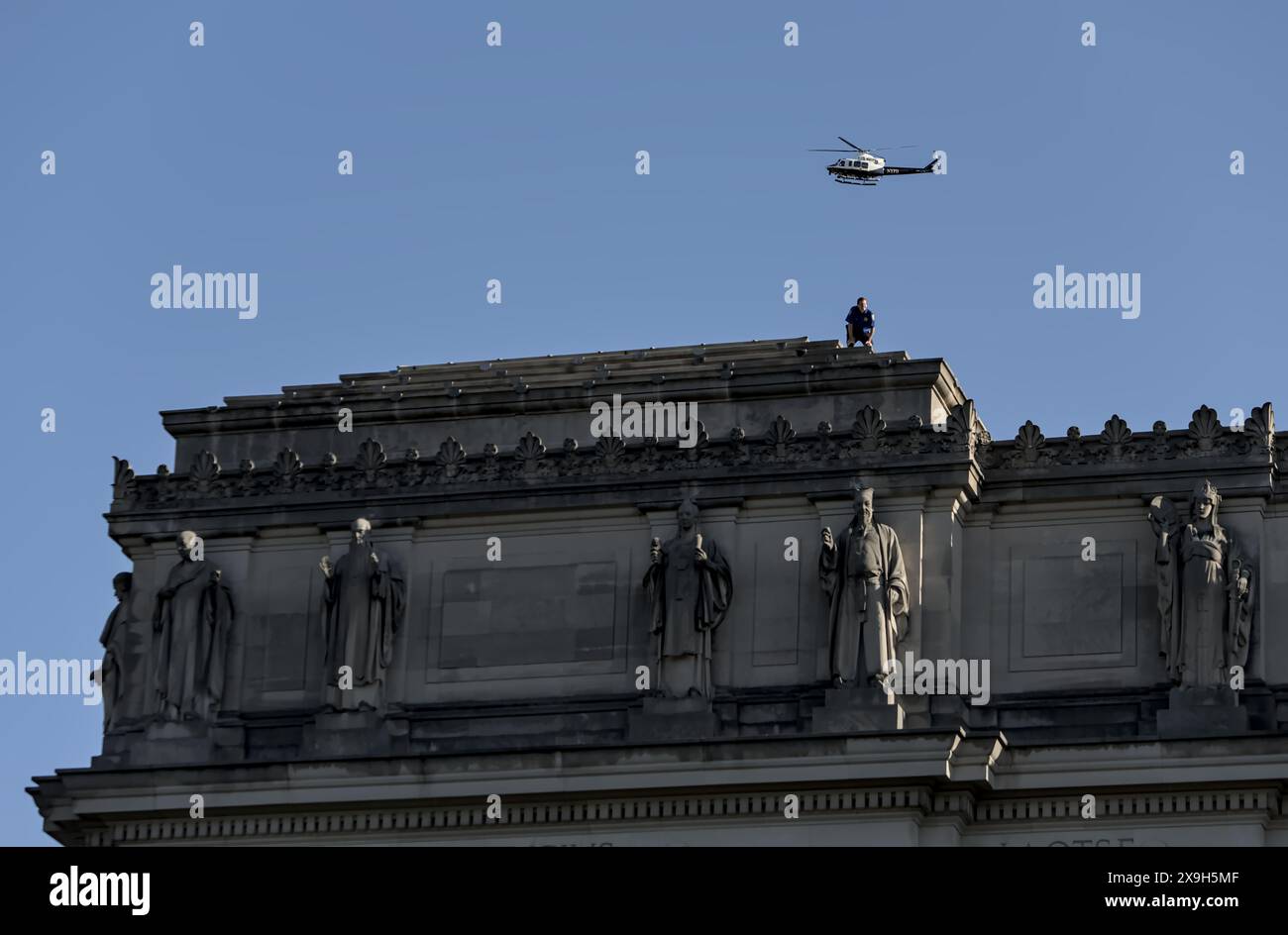 Brooklyn, NY - May 31 2024: Helicopter flies over with NYPD cop on roof ...