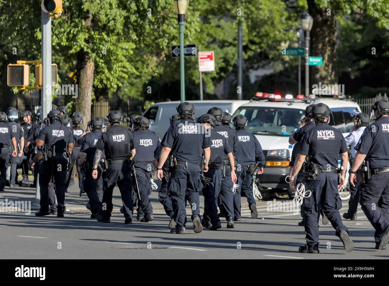 Brooklyn, NY - May 31 2024: NYPD officers carry plastic handcuffs ...