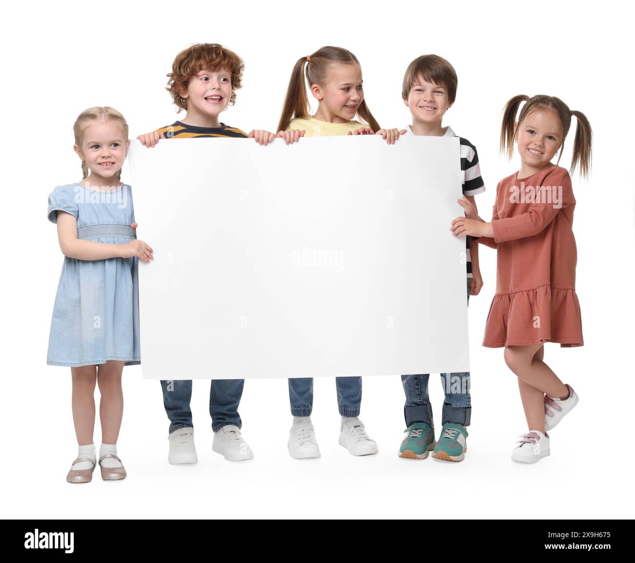 Group of children with blank poster on white background. Mockup for ...