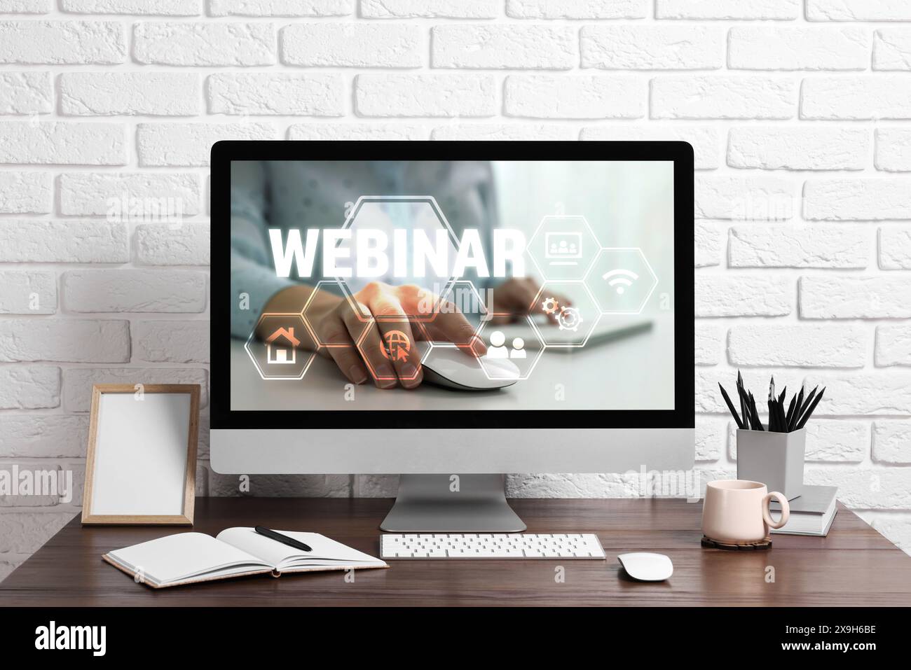Webinar page open on computer screen at workplace Stock Photo - Alamy