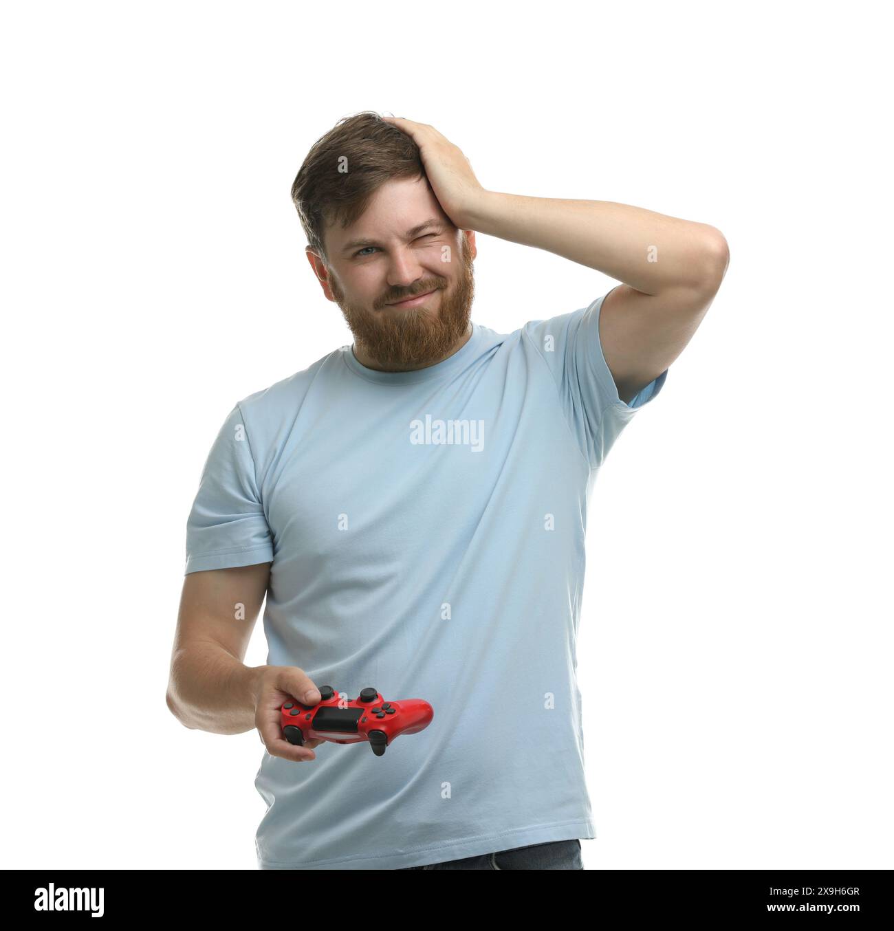 Confused man with game controller on white background Stock Photo - Alamy