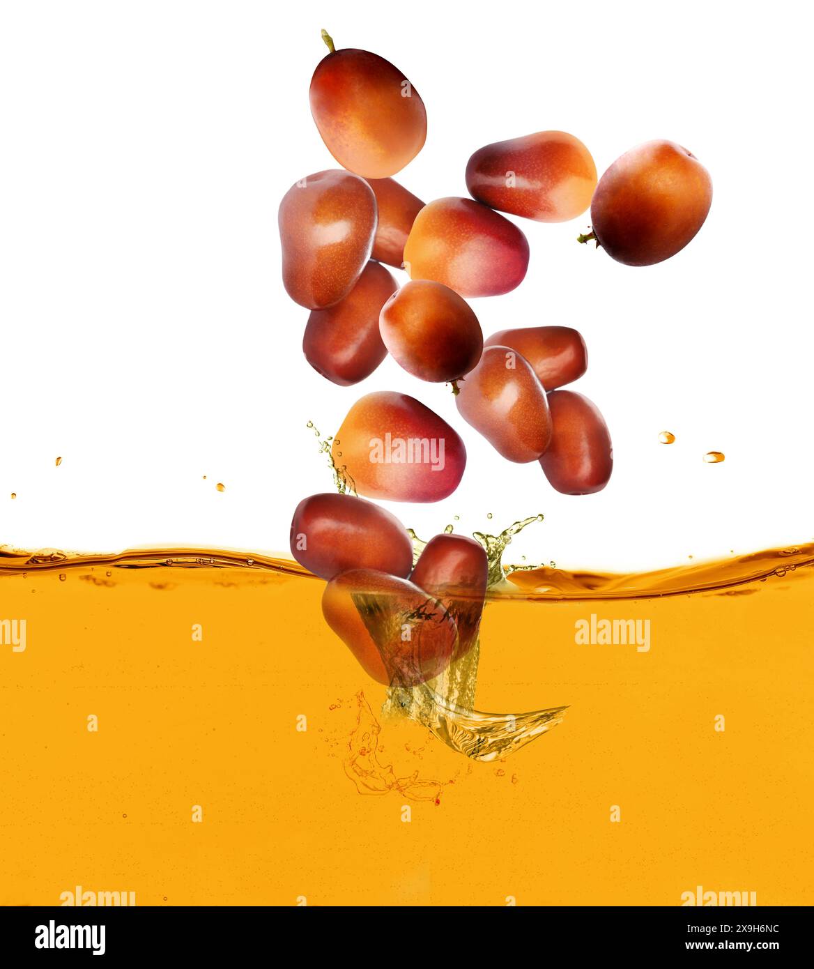 Palm fruits falling into cooking oil on white background Stock Photo ...