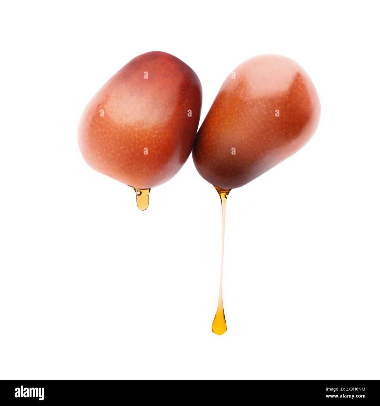 Oil dripping from palm fruits on white background Stock Photo - Alamy