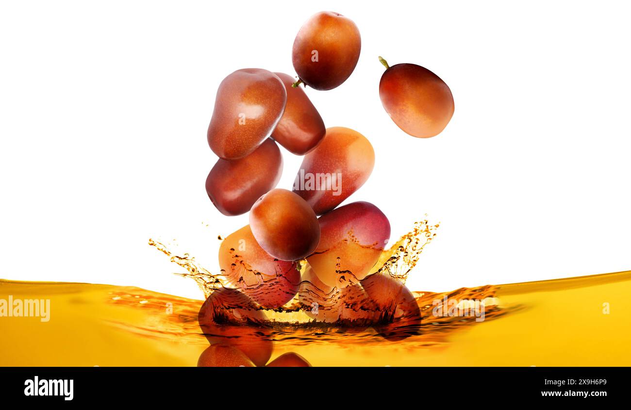 Palm fruits falling into cooking oil on white background Stock Photo ...