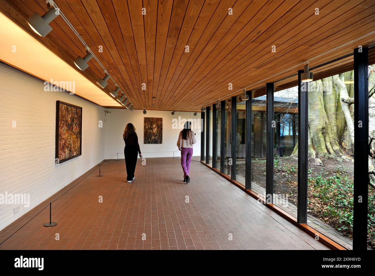 Interior gallery walkway with art and windows to outside at the ...