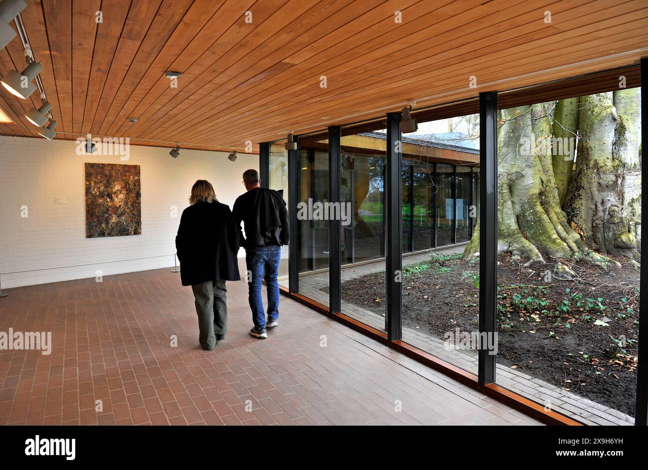 Interior gallery walkway with art and windows to outside at the ...