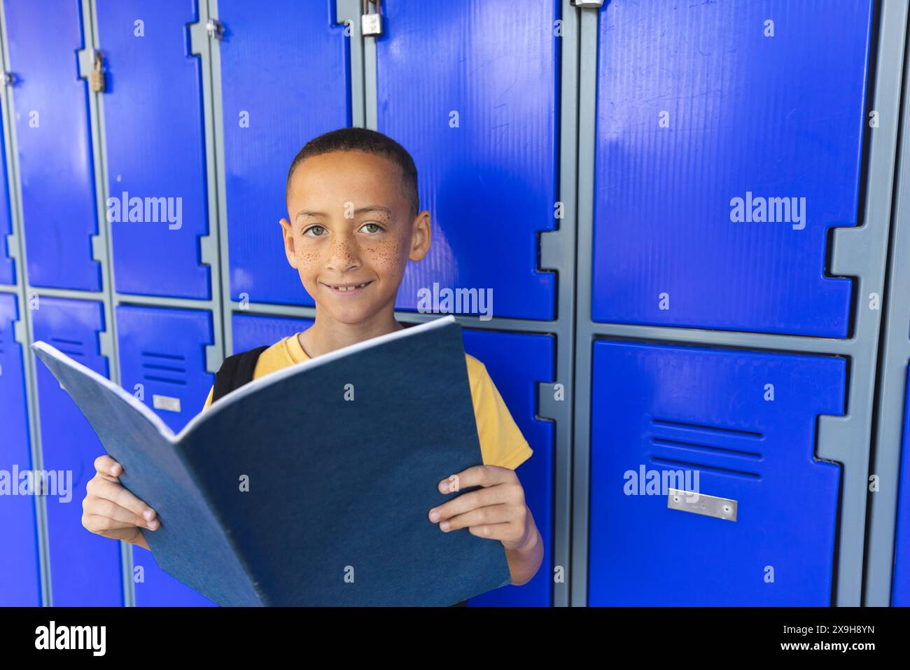 Biracial boy stands in front of school lockers, with copy space Stock ...