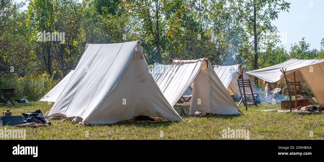 tents are set up at this civil war reenactment, showing a old fashioned ...