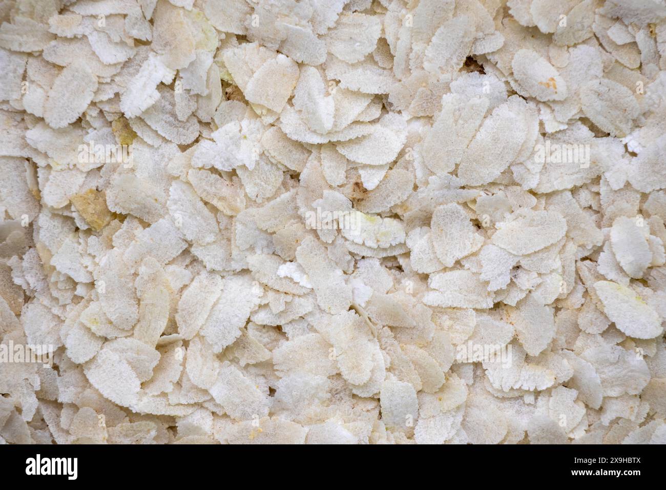 Flattened rice or Chira as background. It is also known as pohe, aval ...