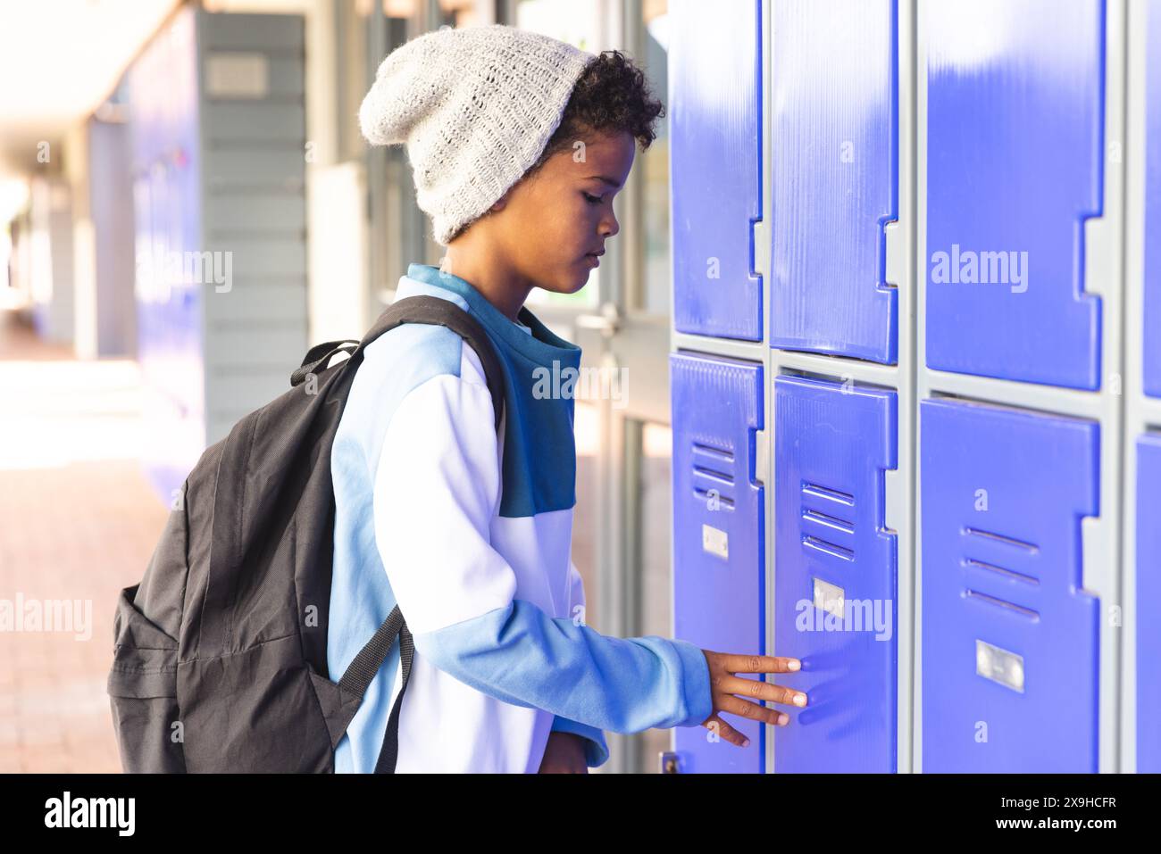 Biracial boy at school locker, with copy space Stock Photo - Alamy