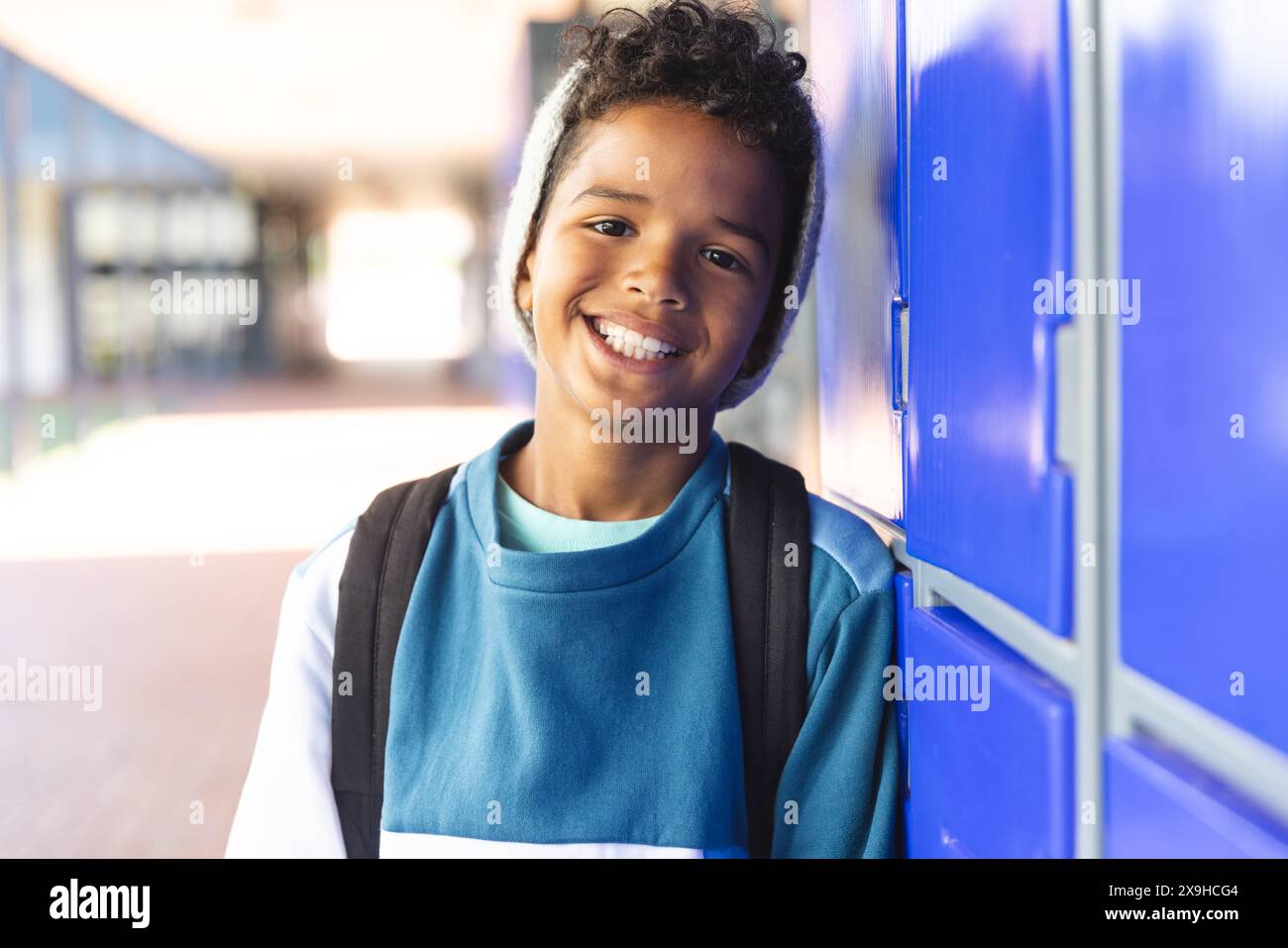 Biracial boy smiling at school, with copy space Stock Photo - Alamy