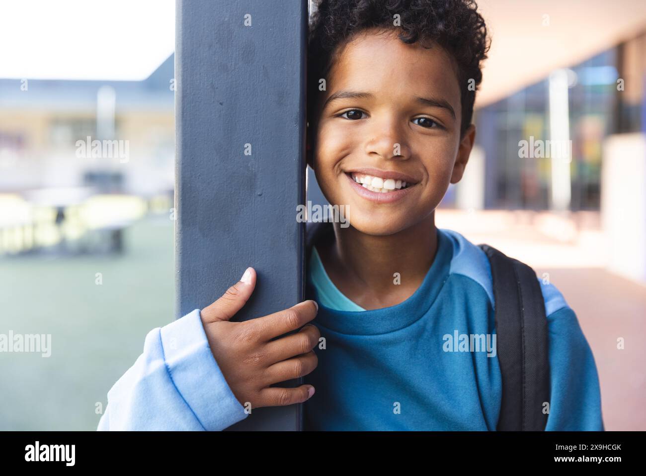 Biracial boy smiles at school, with copy space Stock Photo - Alamy