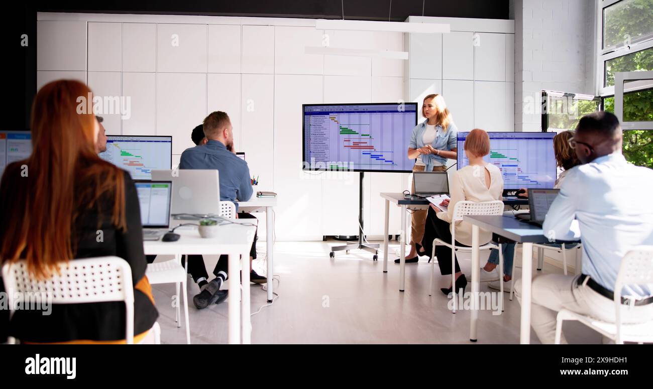 Corporate Training In A Black Classroom With Computer Background Stock ...