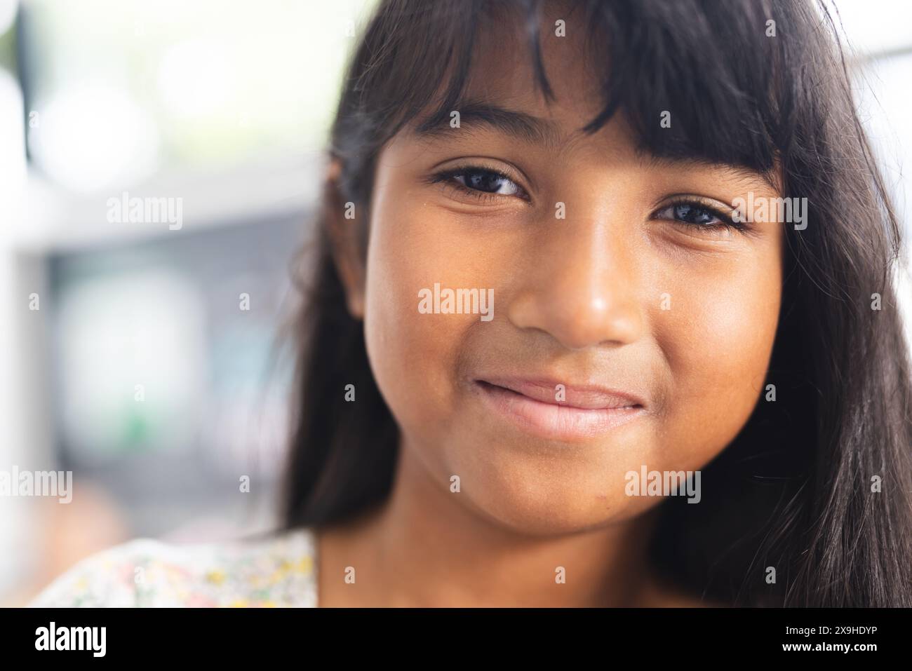 Biracial girl with a gentle smile, her dark hair falls softly around ...