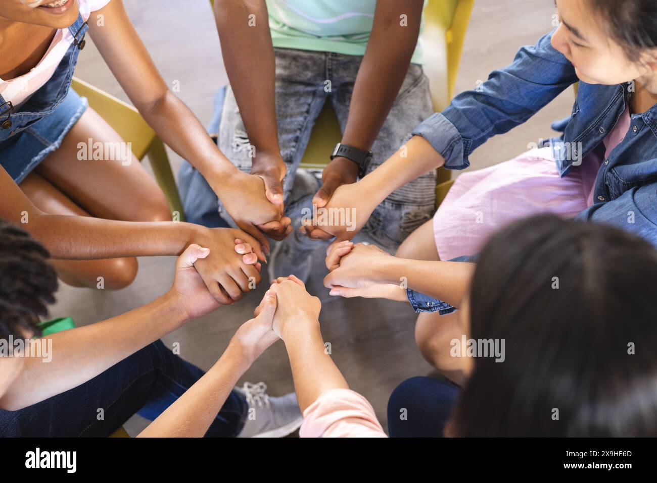 Diverse teenagers join hands in a show of unity at high school ...