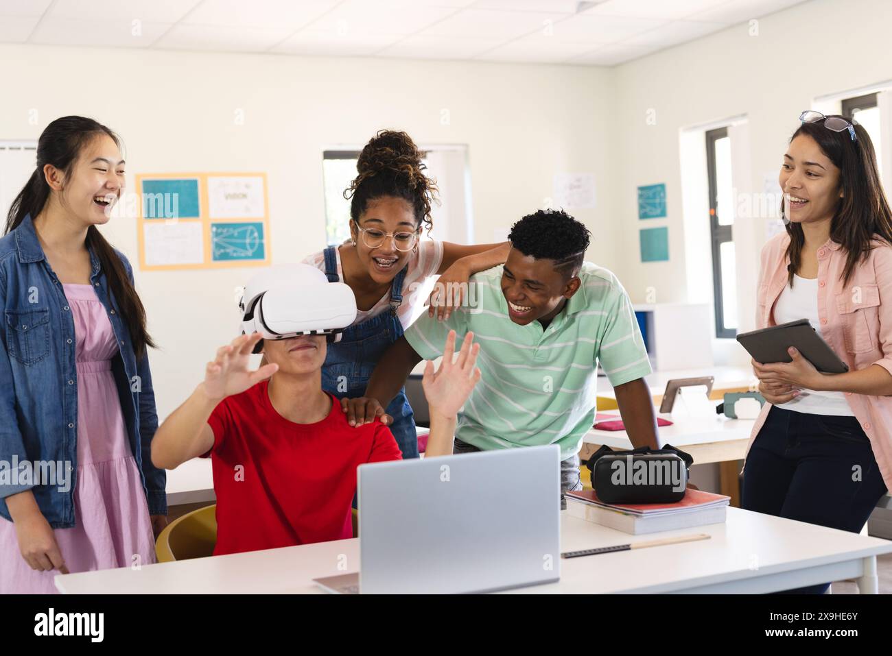 Diverse high school students explore virtual reality in a classroom ...