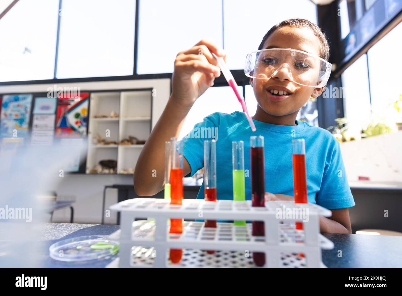 Biracial boy conducts an experiment in a science classroom at school Stock Photo - Alamy