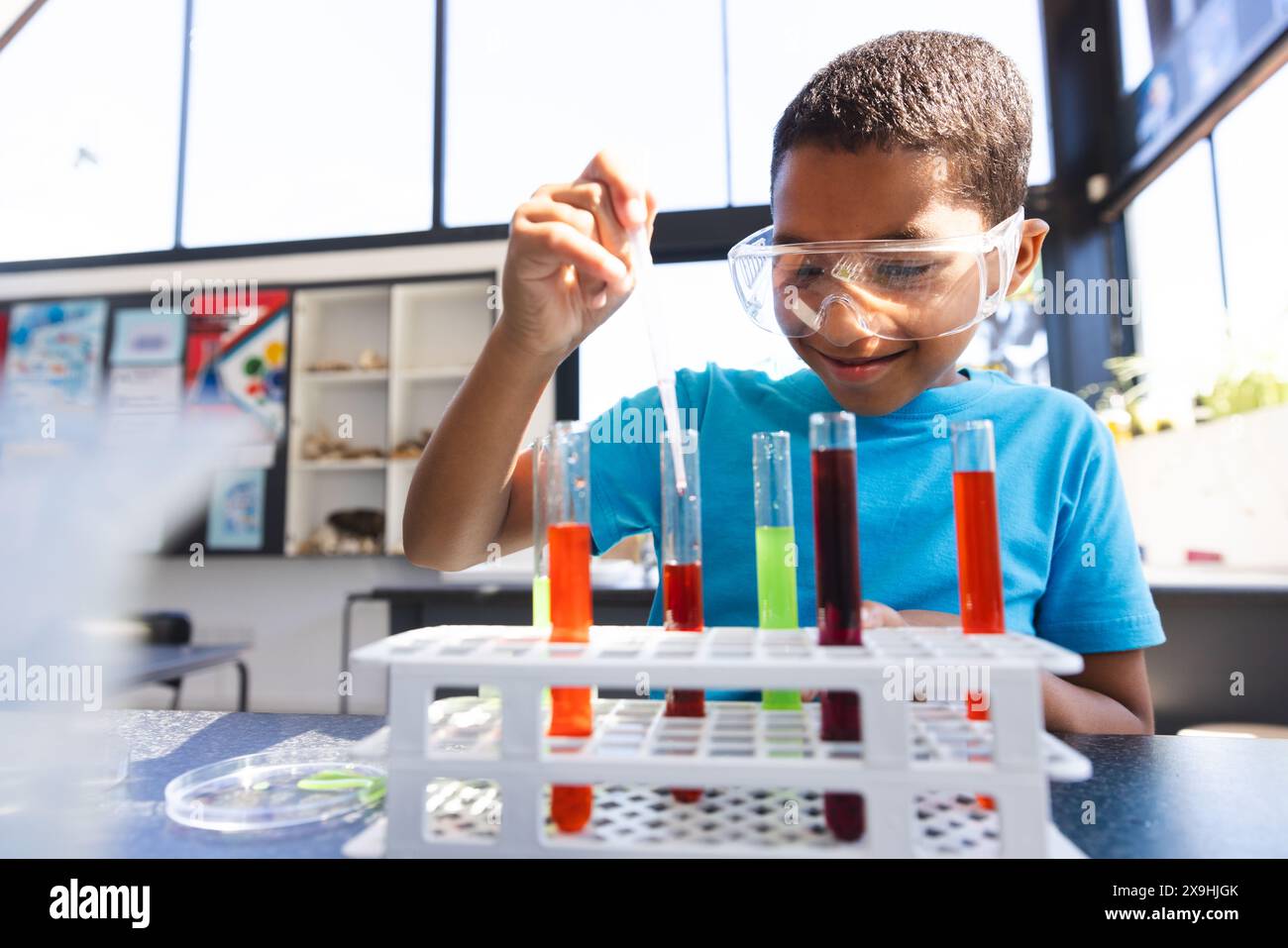 Biracial boy engages in a science experiment at school Stock Photo - Alamy