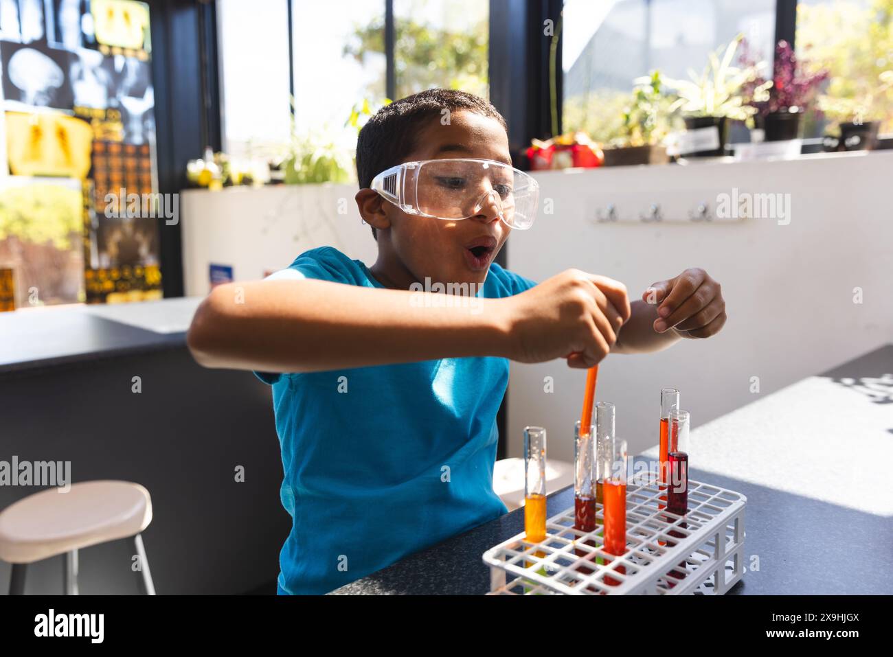 Biracial boy engages in a science experiment at home Stock Photo - Alamy